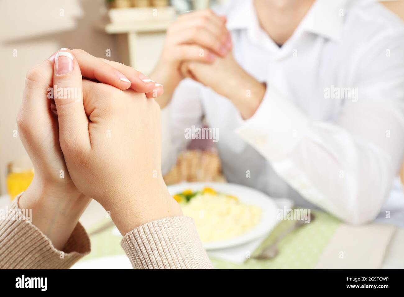 People praying before eating Stock Photo - Alamy