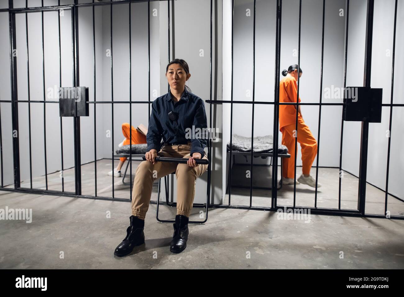A typical day in a women's prison. A bored female guard in uniform sits ...