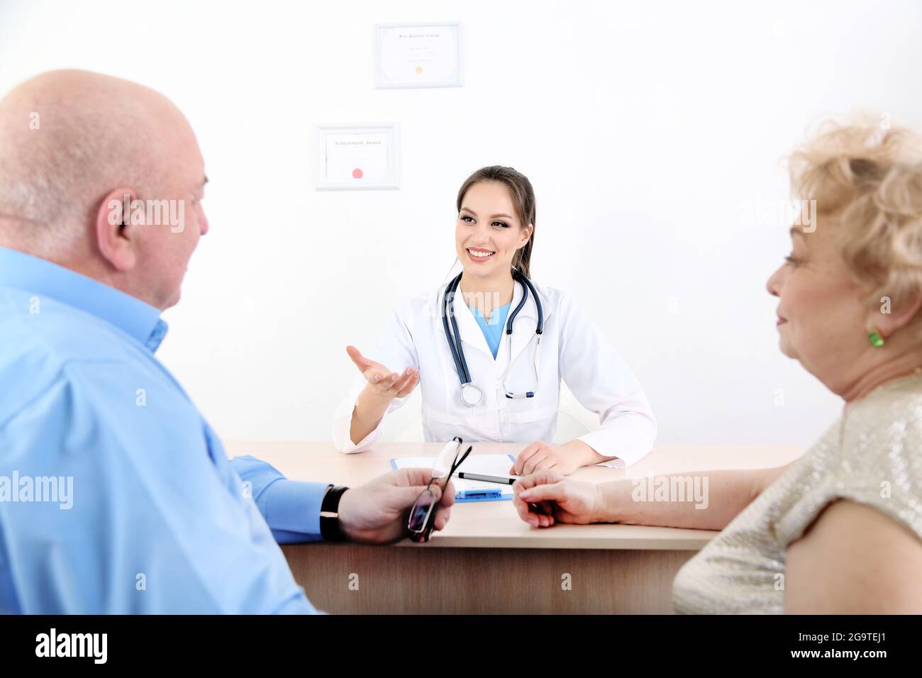 Happy doctor and patients in hospital clinic Stock Photo - Alamy