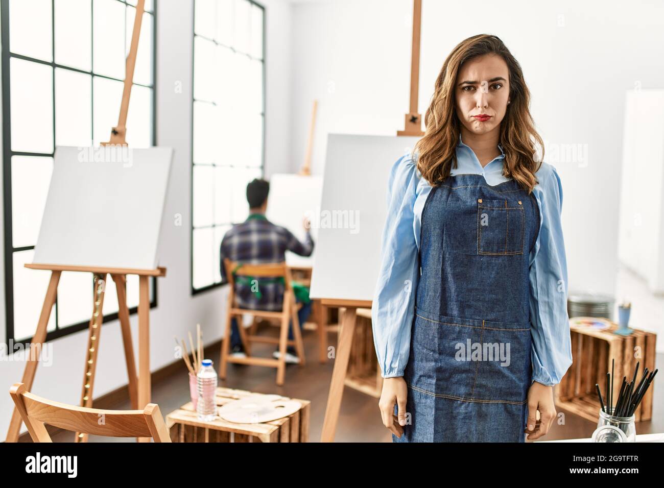 Young artist woman at art studio depressed and worry for distress ...