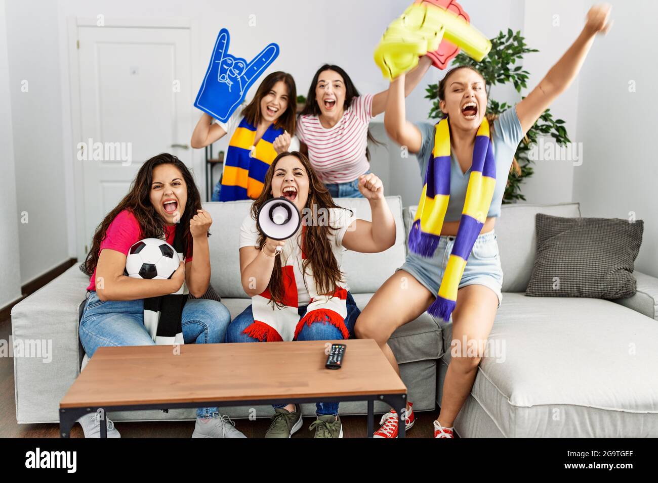 Group of young women watching and supporting soccer match at home Stock ...