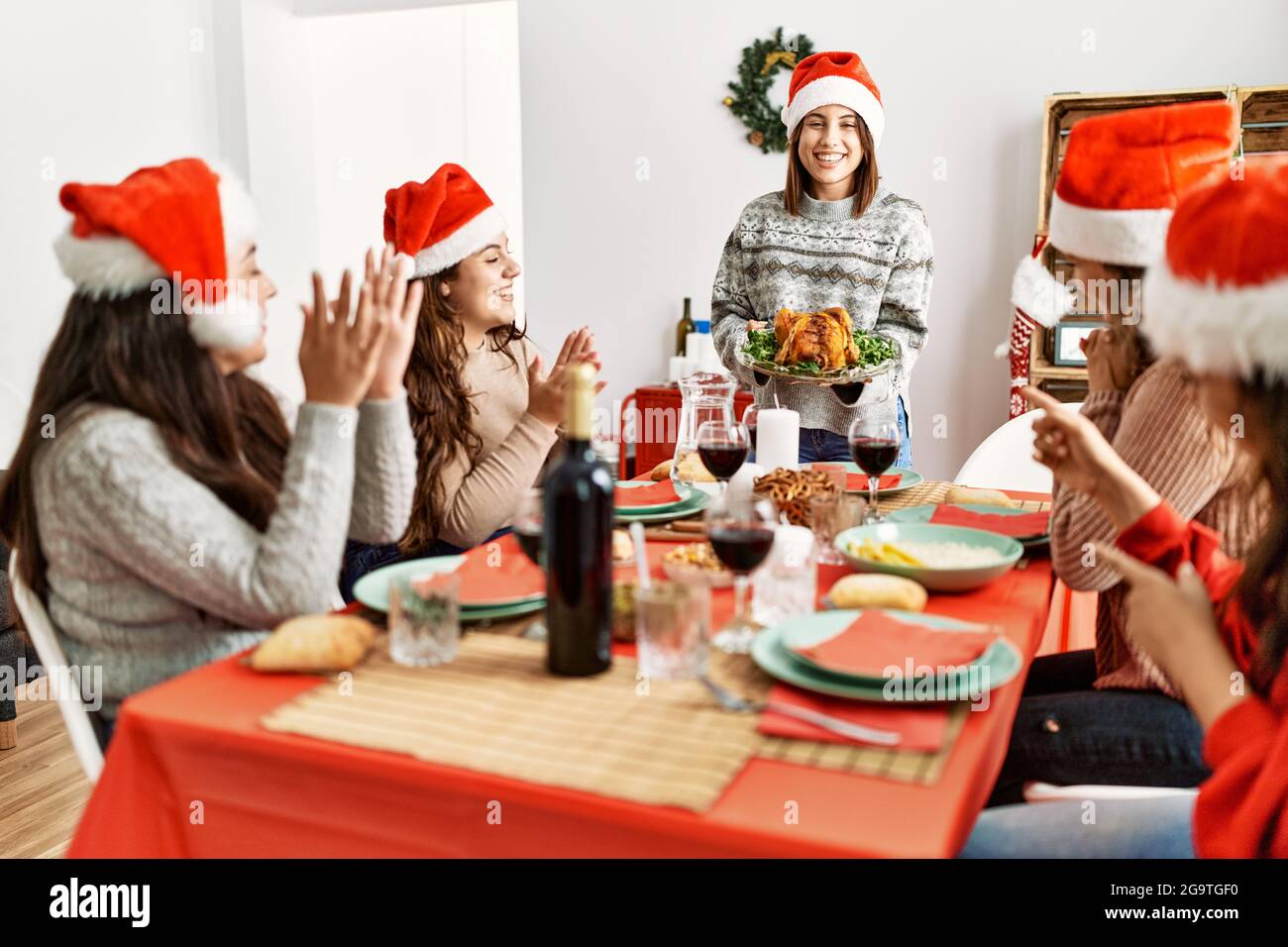 Group of hispanic women clapping and sitting on the table. Woman ...