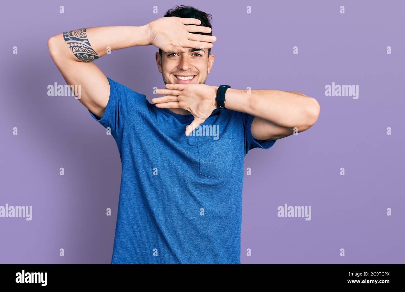 Young hispanic man wearing casual t shirt smiling cheerful playing peek ...