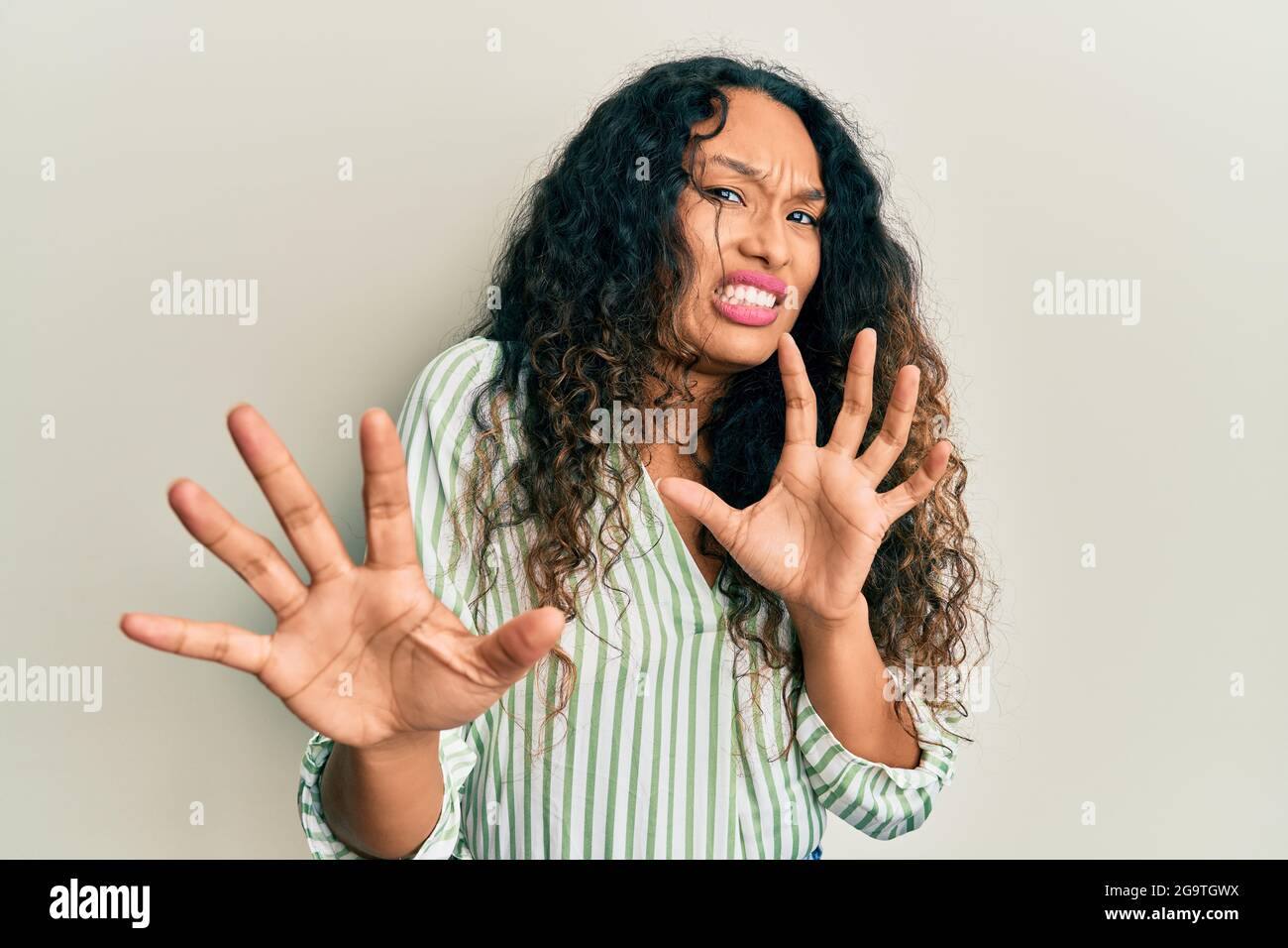 Young latin woman wearing casual clothes disgusted expression ...
