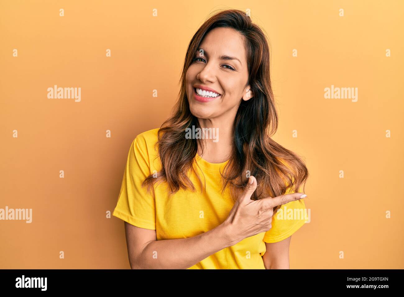 Young latin woman wearing casual clothes cheerful with a smile of face ...