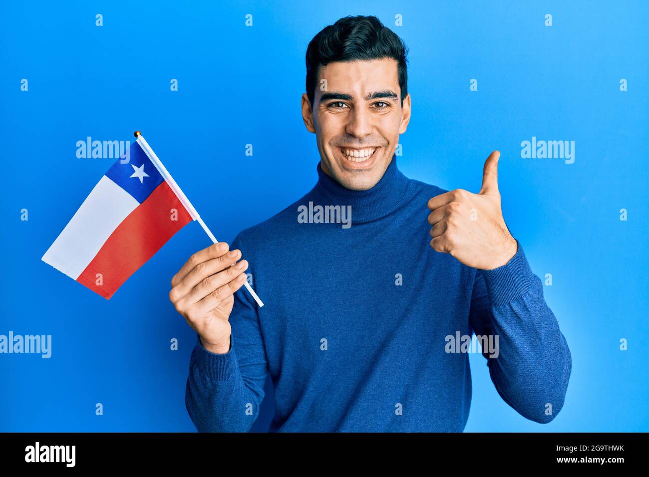 Handsome hispanic business man holding chile flag smiling happy and ...