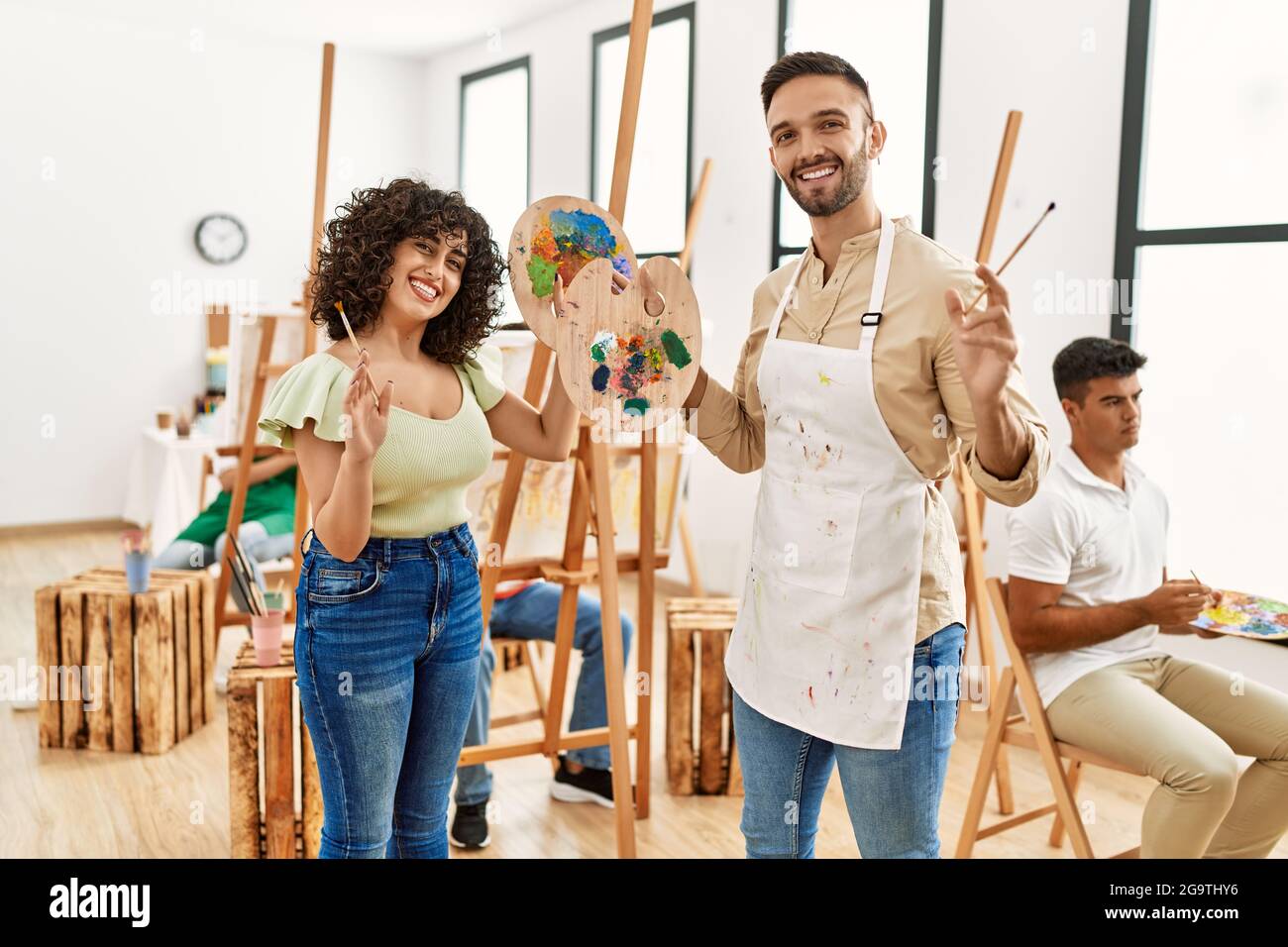 Group of people drawing at art studio. Man and woman smiling happy ...