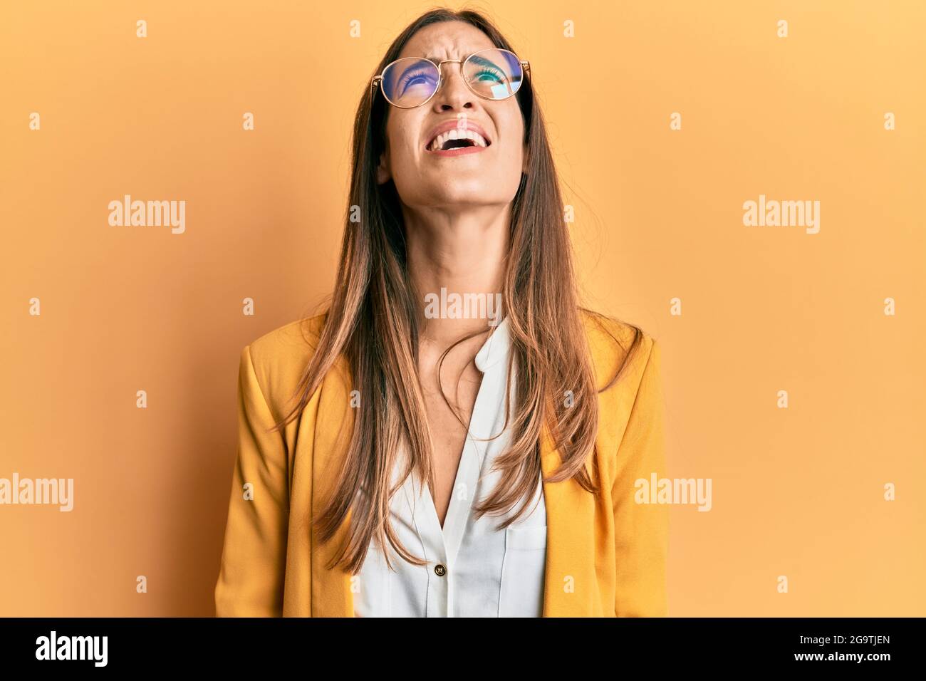 Young beautiful woman wearing business style and glasses angry and mad ...