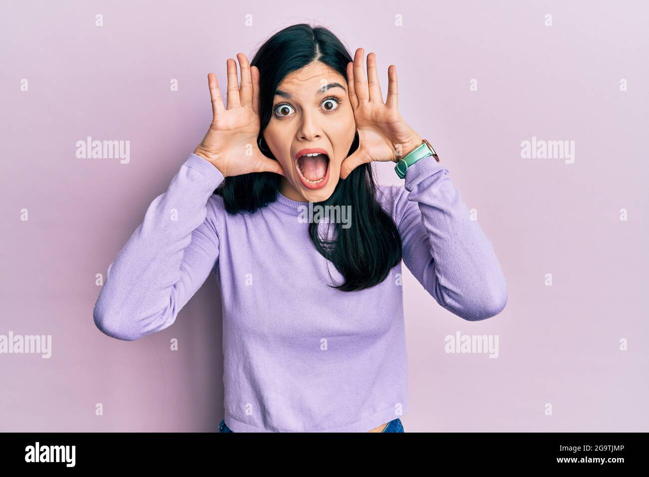 Young hispanic woman wearing casual clothes smiling cheerful playing ...