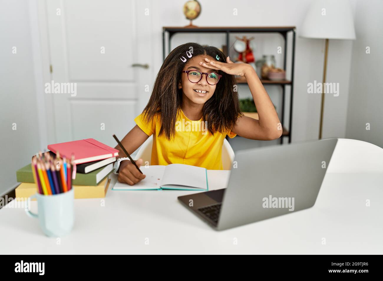 Young african american girl doing homework at home very happy and ...