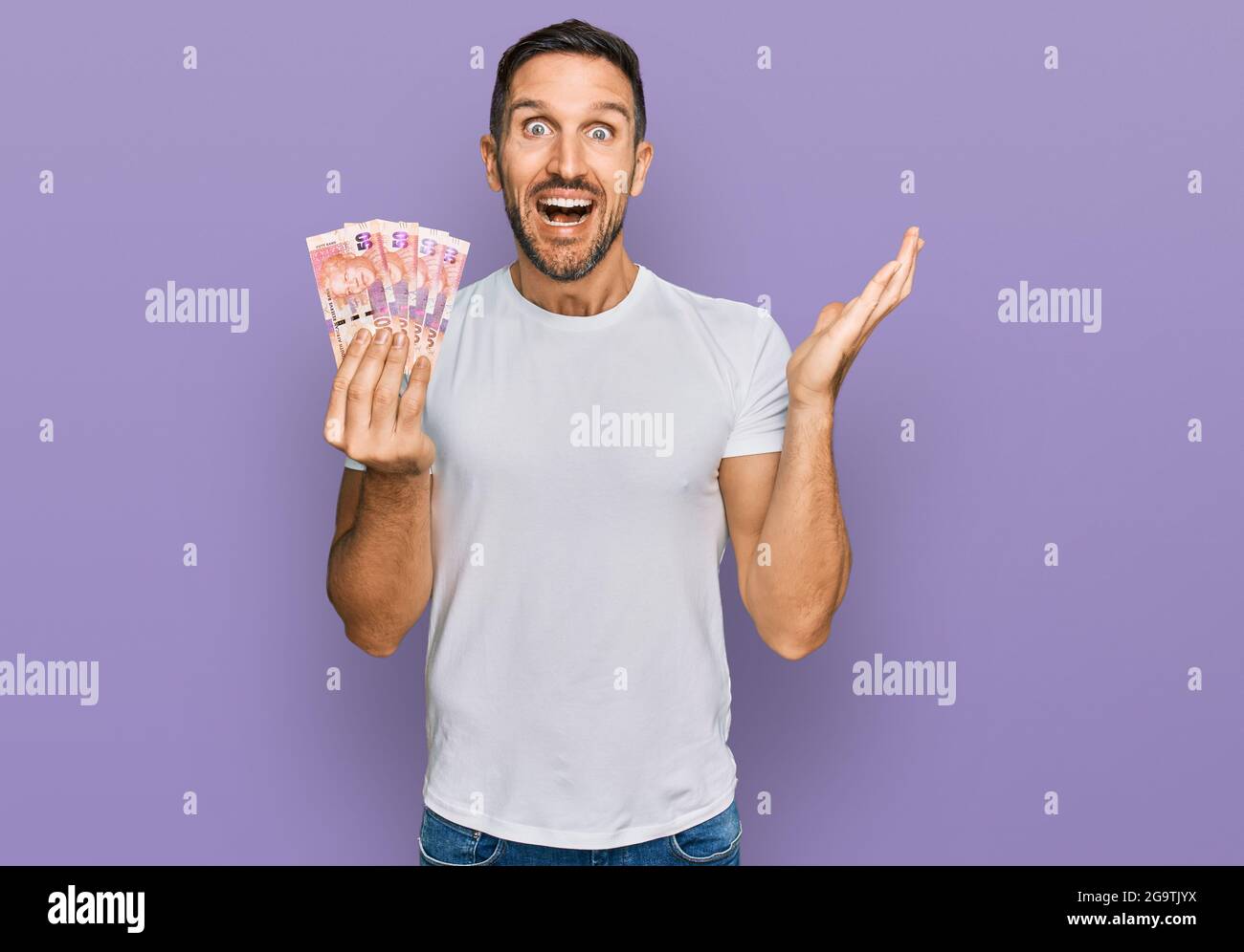 Handsome man with beard holding south african 50 rand banknotes ...