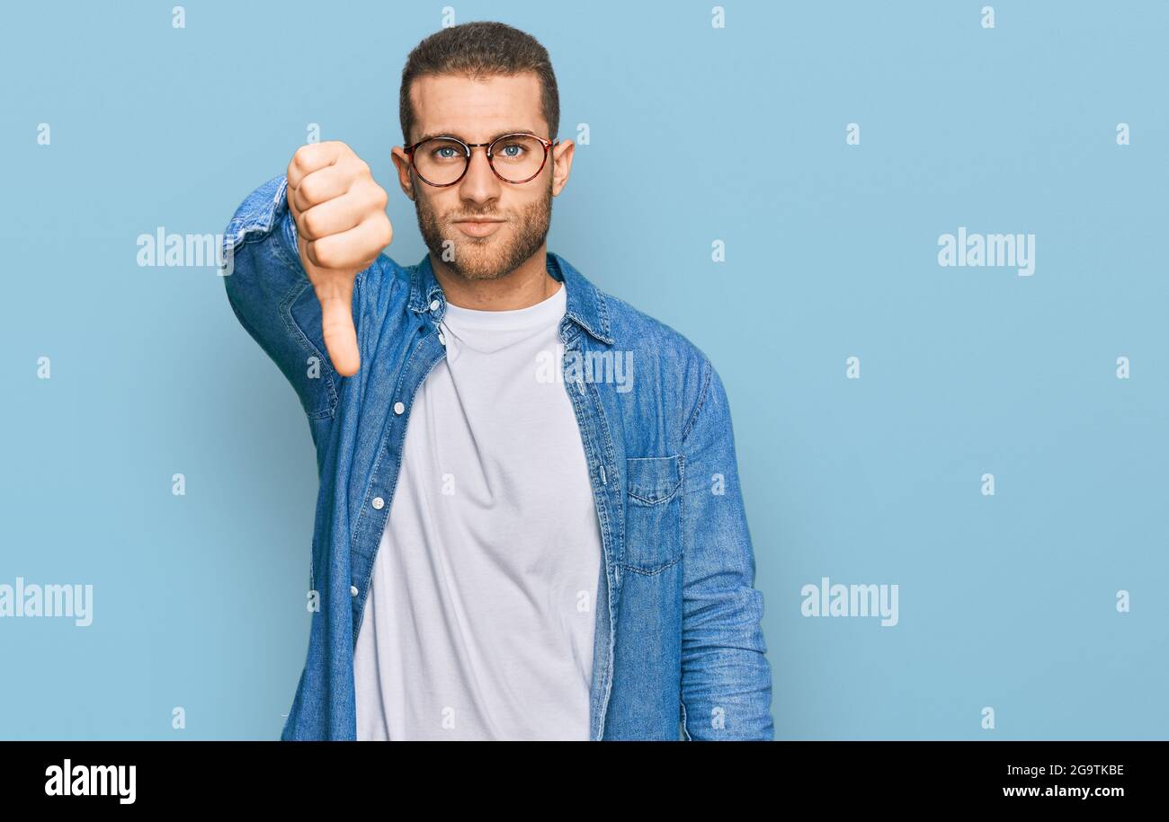 Young caucasian man wearing casual clothes looking unhappy and angry ...