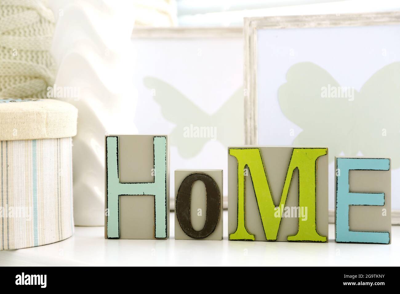 Home in colorful letters in light white interior Stock Photo - Alamy