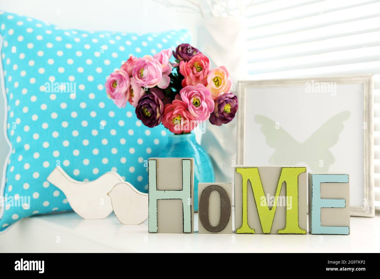 Home in colorful letters in light white interior Stock Photo - Alamy