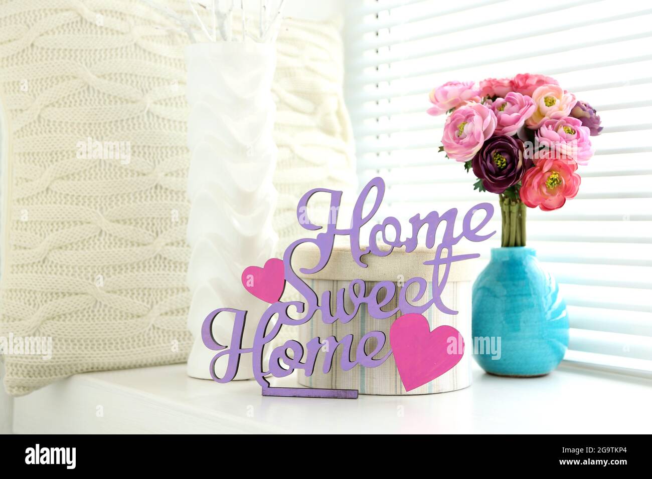 Home in colorful letters in light white interior Stock Photo - Alamy