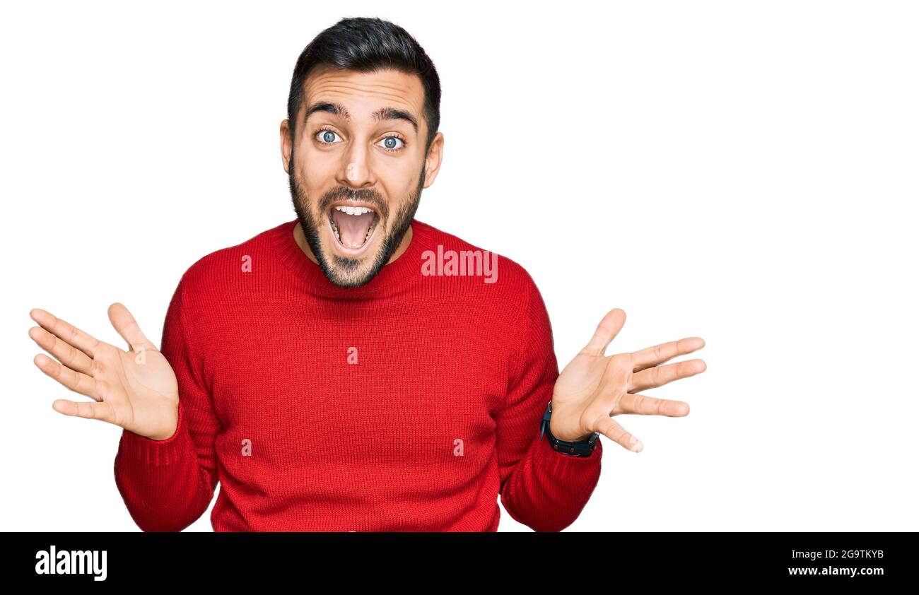 Young hispanic man wearing casual clothes celebrating crazy and amazed ...