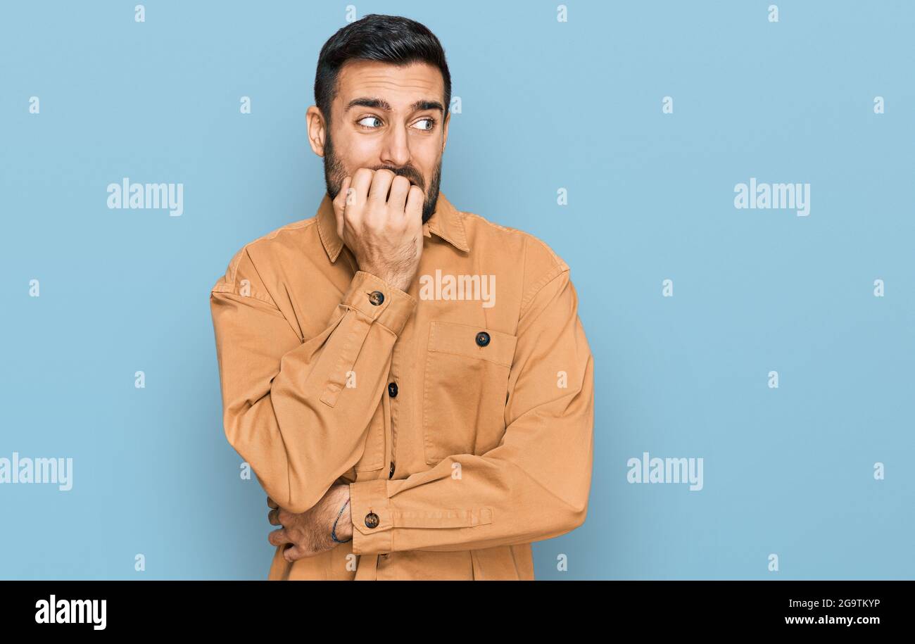 Young hispanic man wearing casual clothes looking stressed and nervous ...