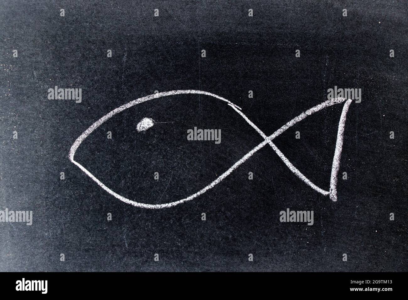 White chalk drawing in fish shape on black board background Stock Photo ...
