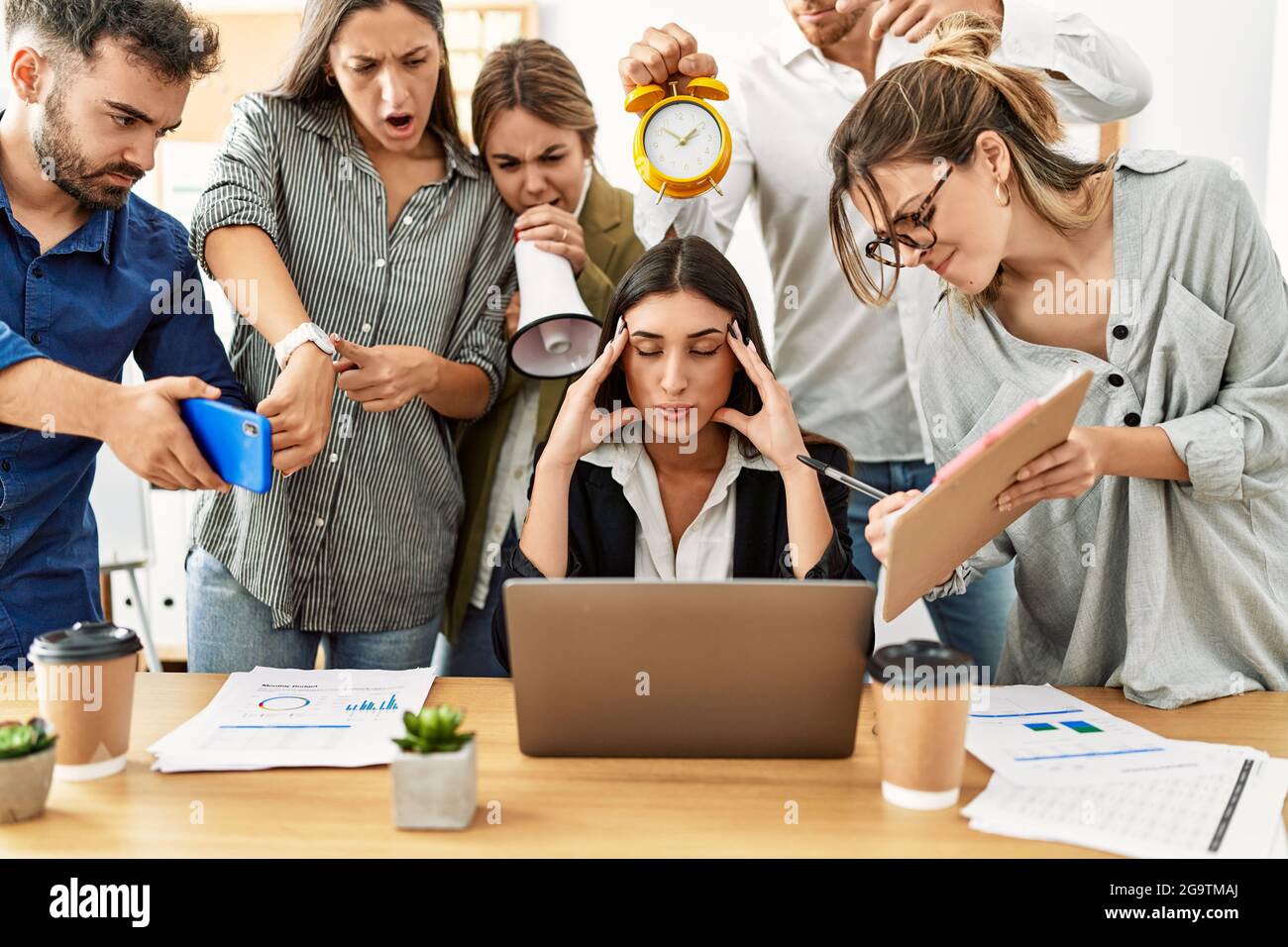 Group of business workers screaming to stressed partner at the office ...