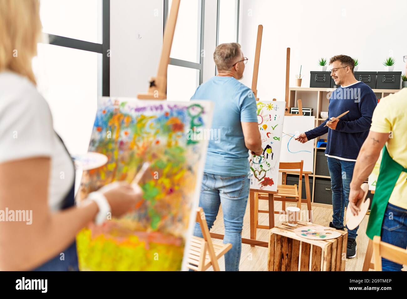 Group of middle age paint students having art class at drawing studio ...