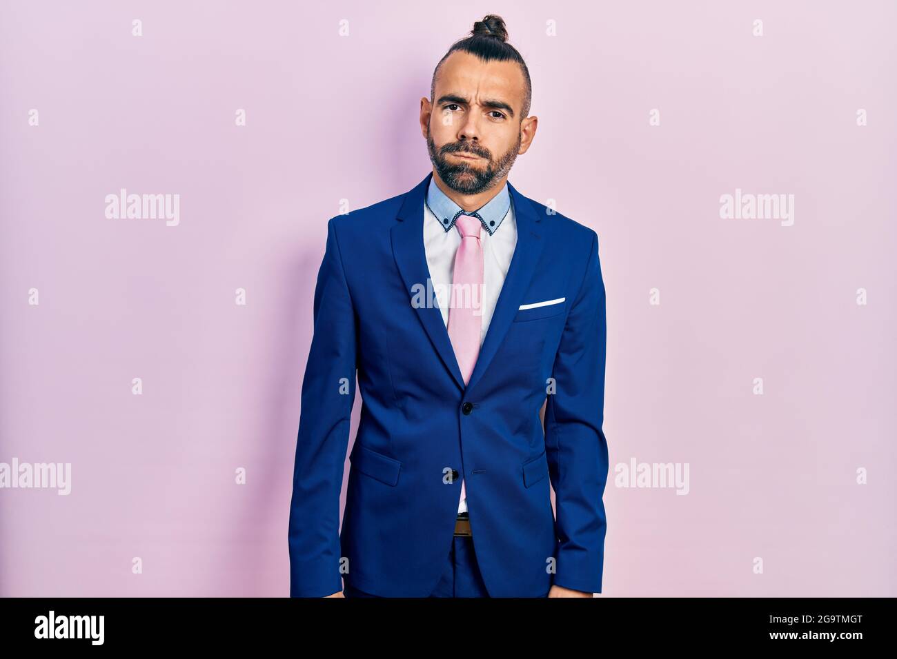 Young hispanic man wearing business suit and tie puffing cheeks with ...