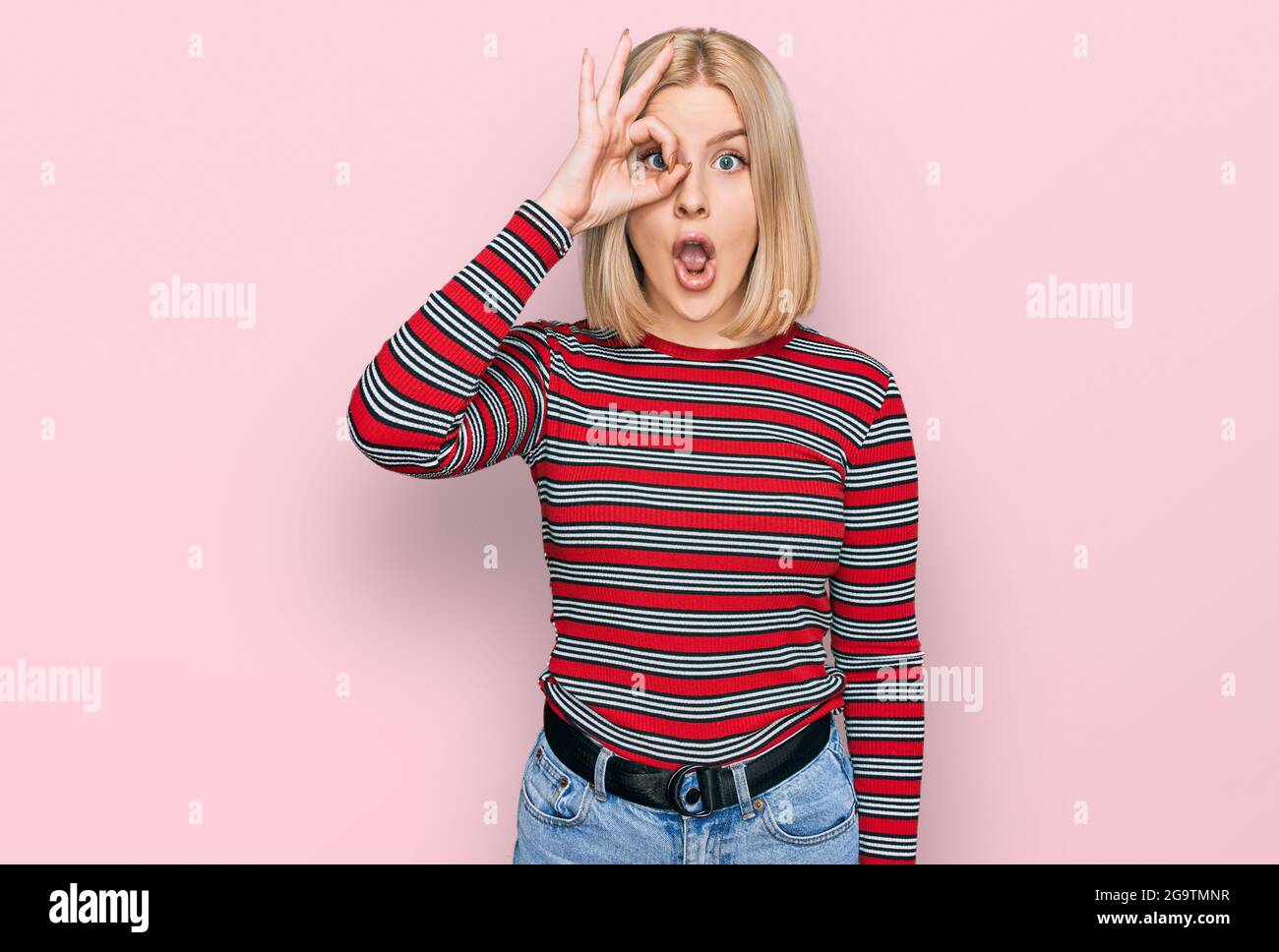 Young blonde woman wearing casual clothes doing ok gesture shocked with ...