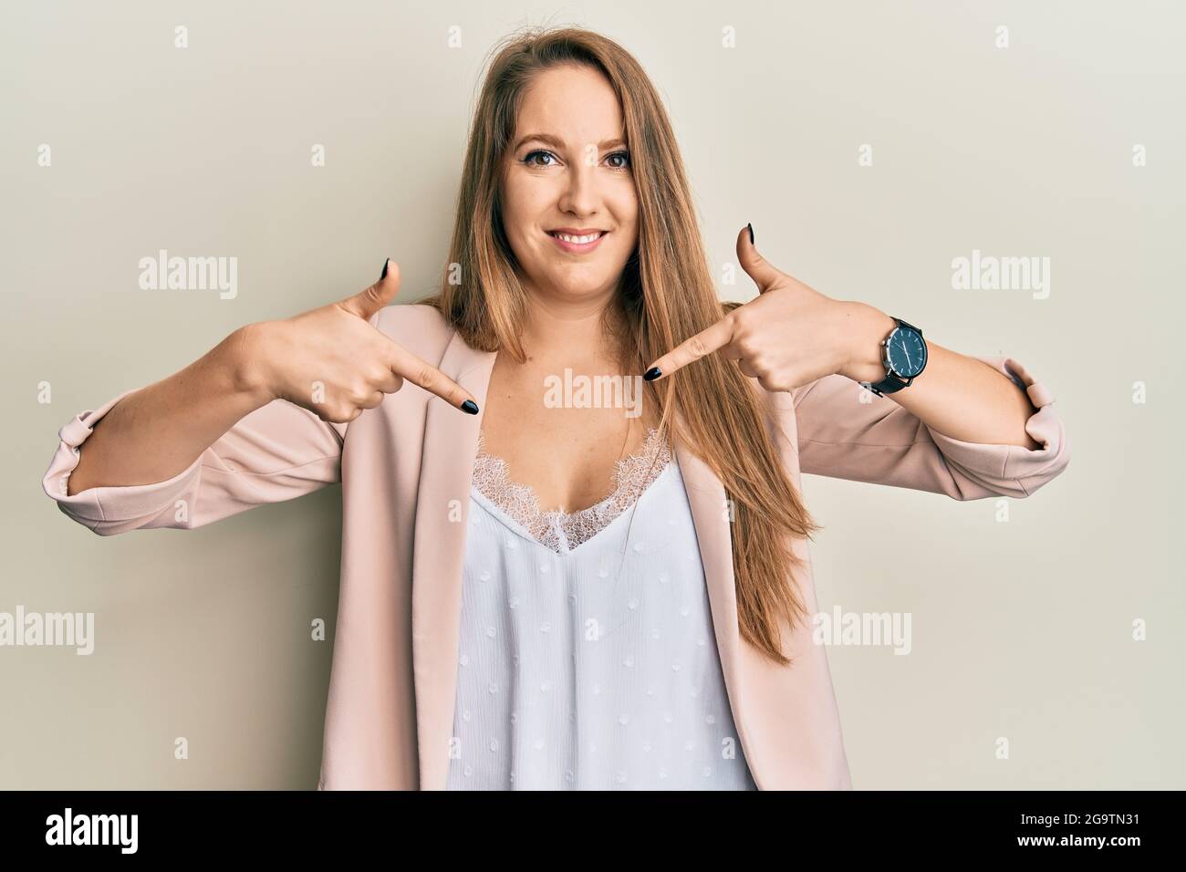 Young blonde woman wearing business jacket and glasses looking ...