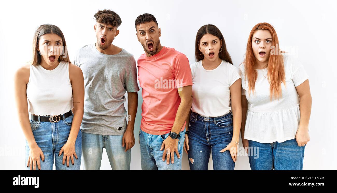 Group of young friends standing together over isolated background in ...