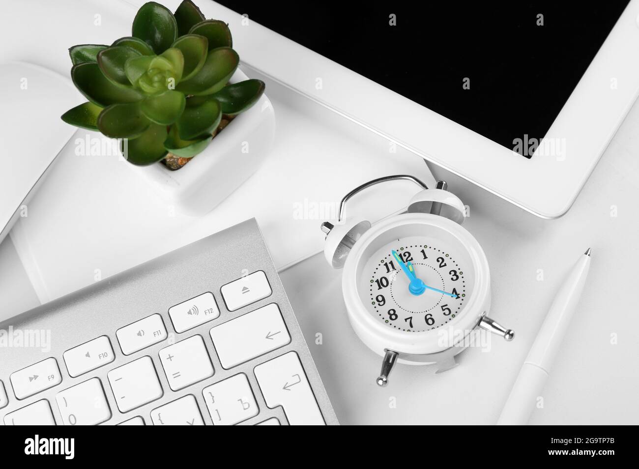Office workplace with tablet and pot plant close up Stock Photo - Alamy