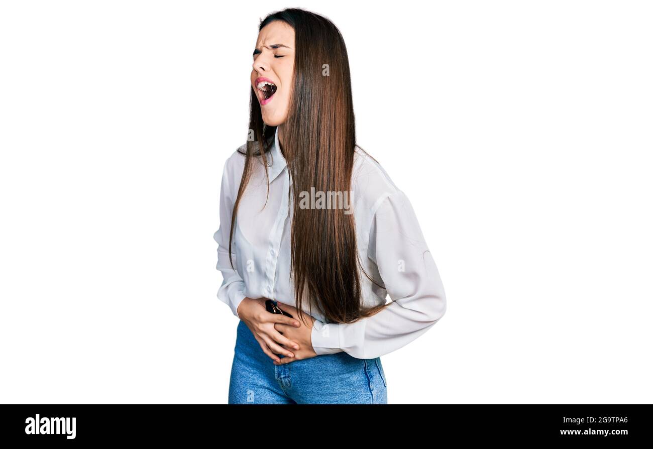 Young brunette teenager wearing business white shirt with hand on ...