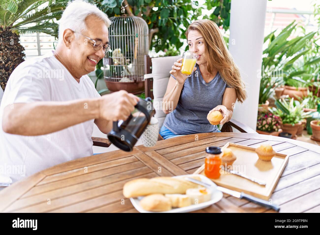 Middle age hispanic couple smiling happy having breakfast at the ...