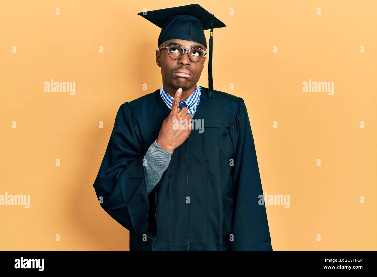 Young african american man wearing graduation cap and ceremony robe ...