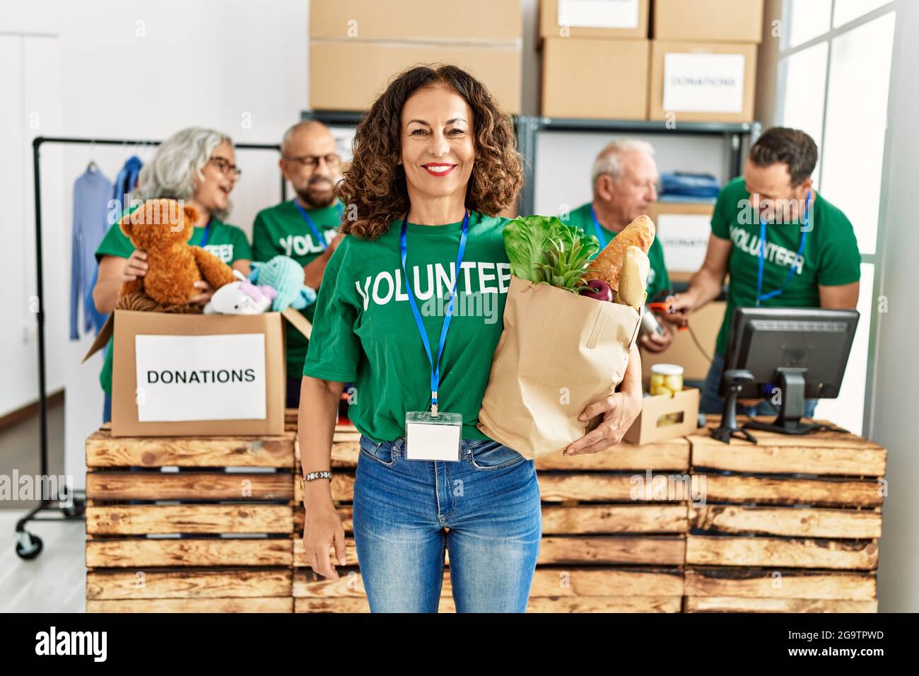 Volunteers friends holding donation boxes hi-res stock photography and ...
