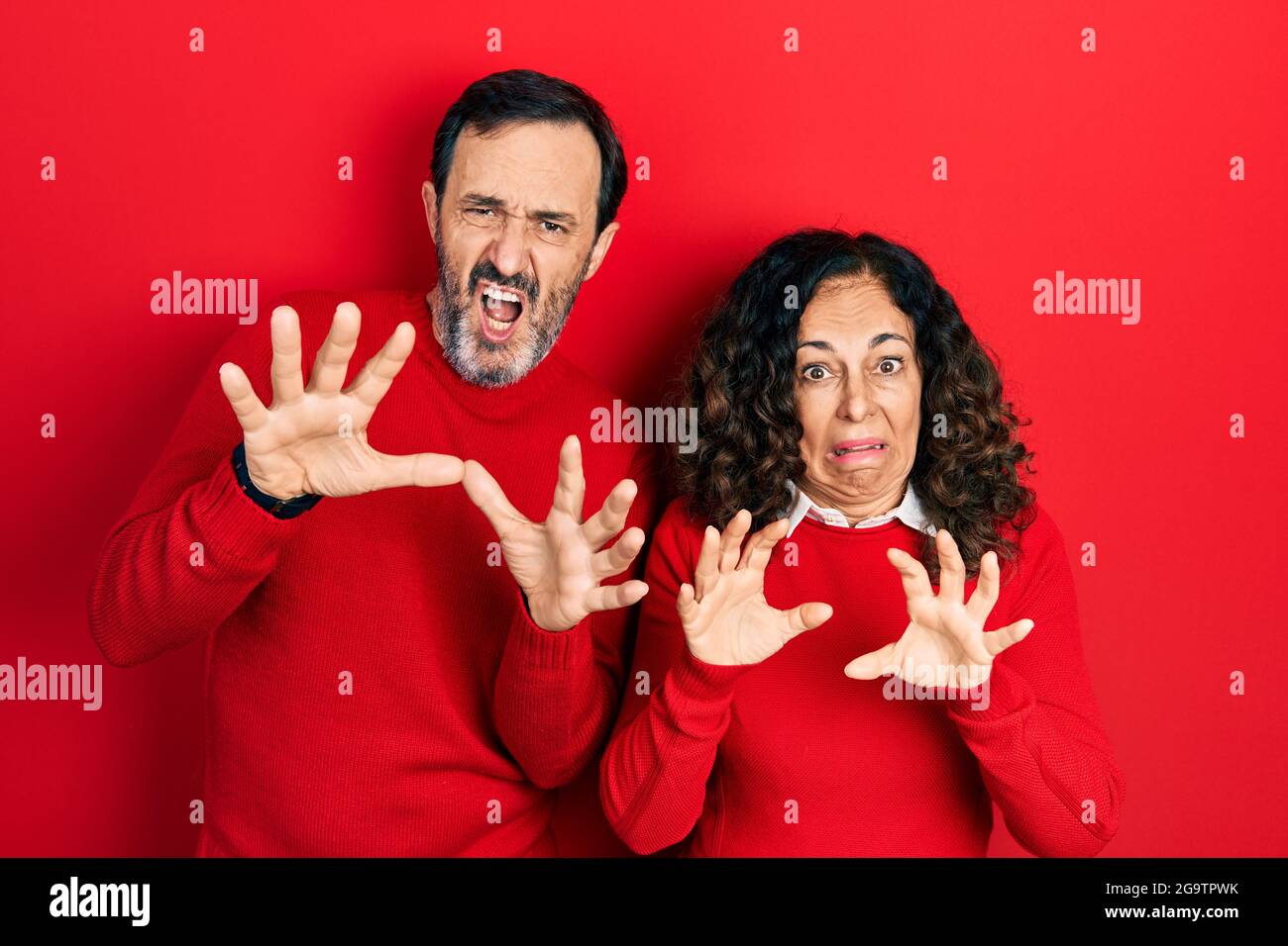 Middle age couple of hispanic woman and man hugging and standing ...