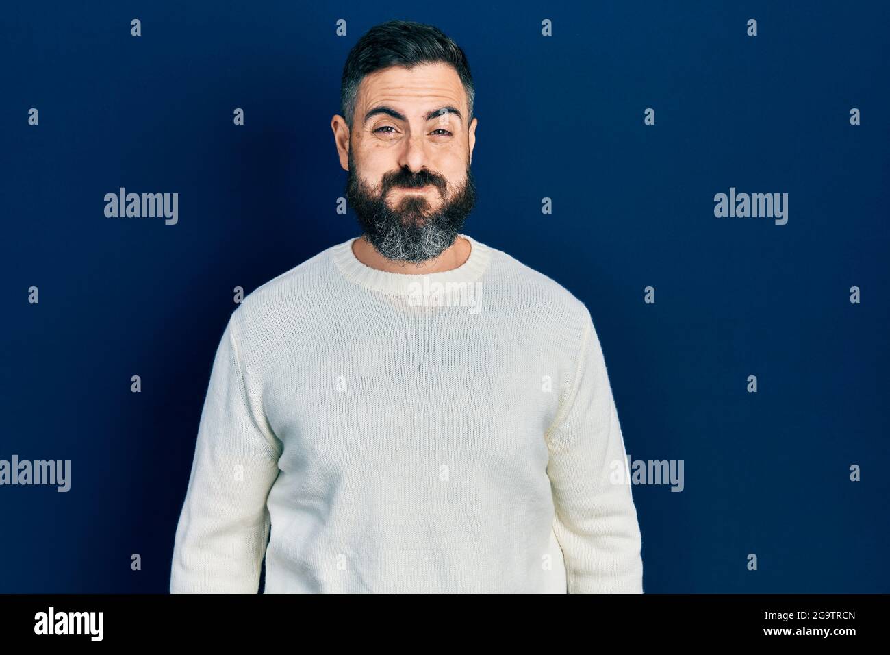 Young hispanic man wearing casual clothes puffing cheeks with funny ...