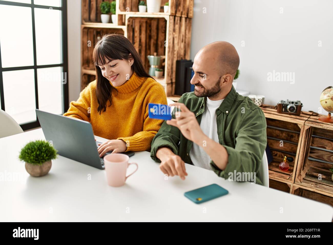 Young hispanic couple smiling happy using laptop and credit card ...