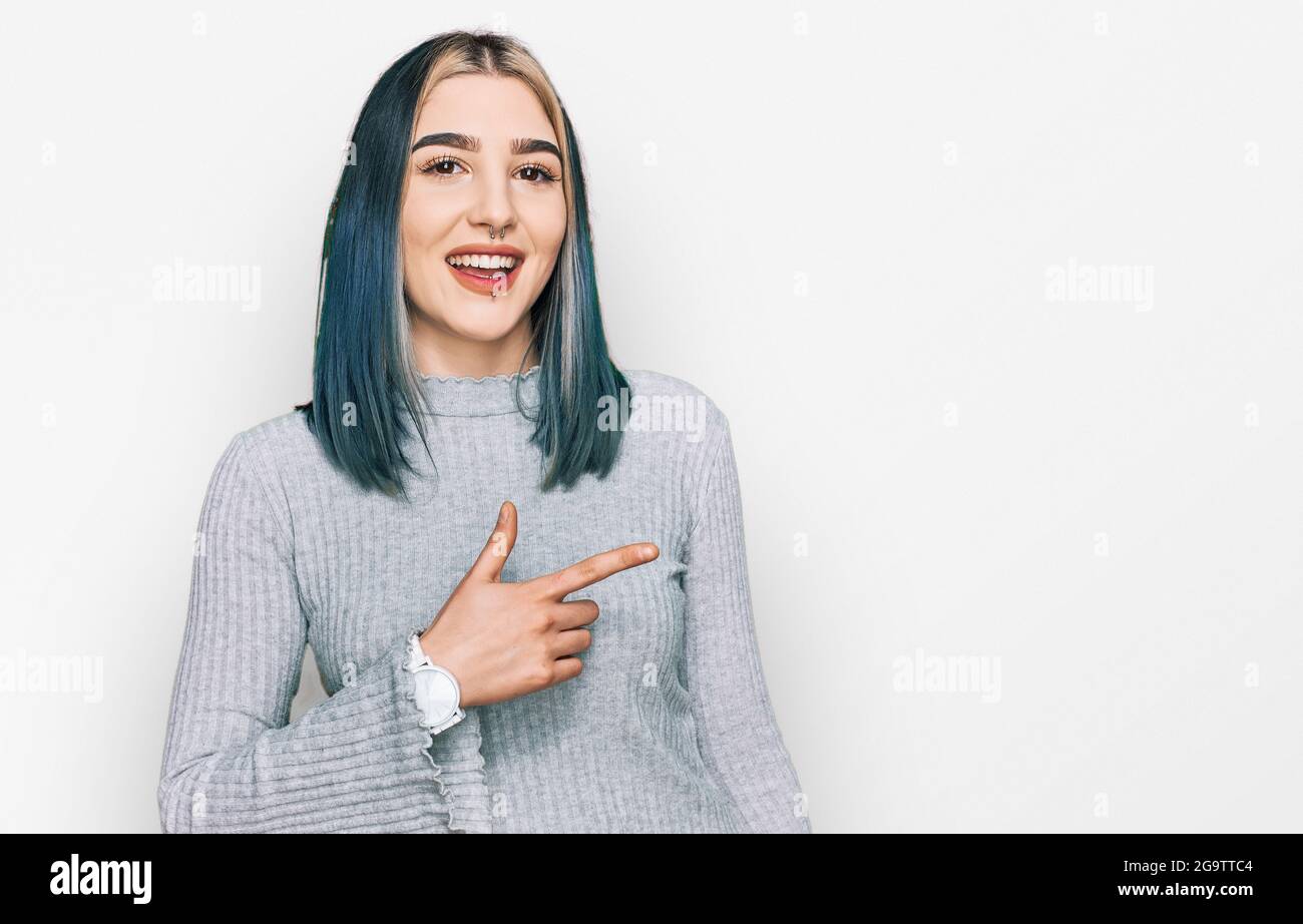 Young modern girl wearing casual sweater cheerful with a smile of face ...