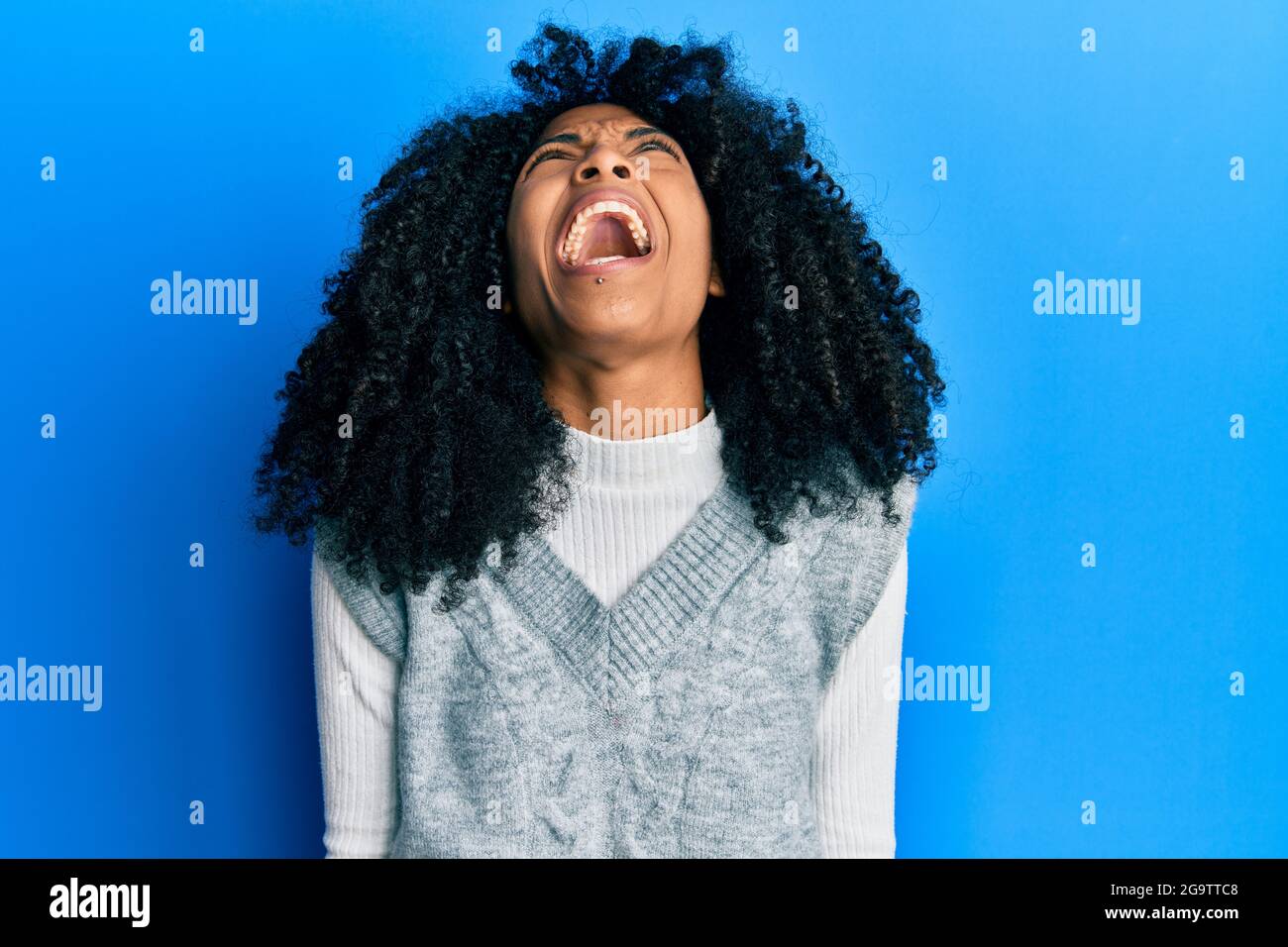 African american woman with afro hair wearing casual winter sweater ...