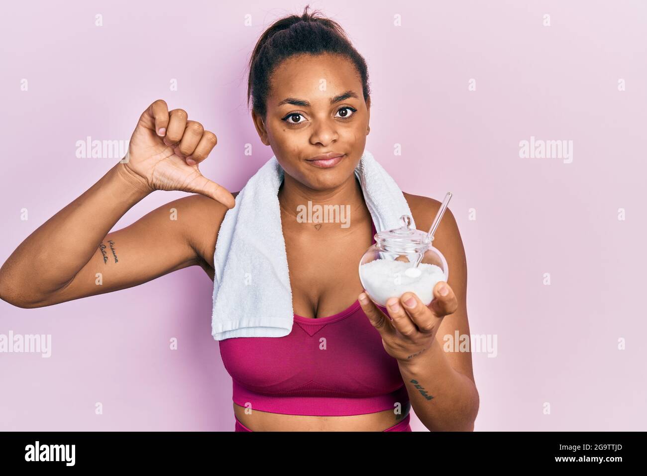 Young african american girl wearing sportswear holding sugar with angry ...