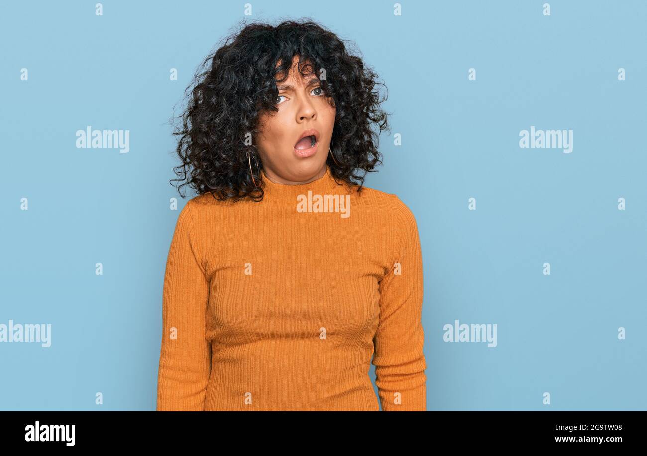 Young hispanic woman wearing casual clothes in shock face, looking ...