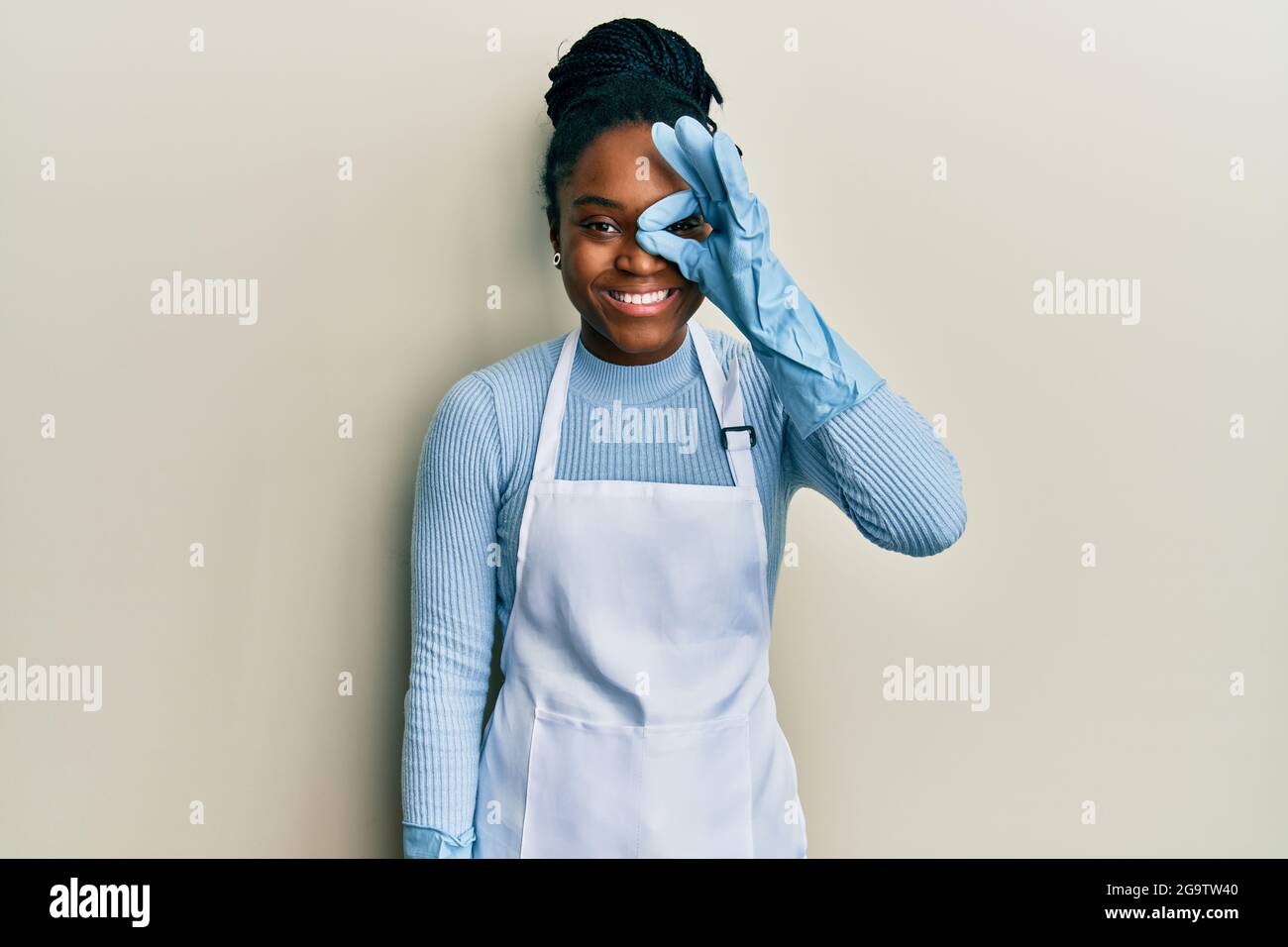 African american woman with braided hair wearing cleaner apron and ...