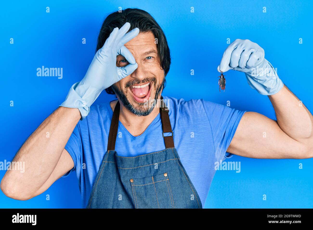 Middle age caucasian man holding cockroach smiling happy doing ok sign ...