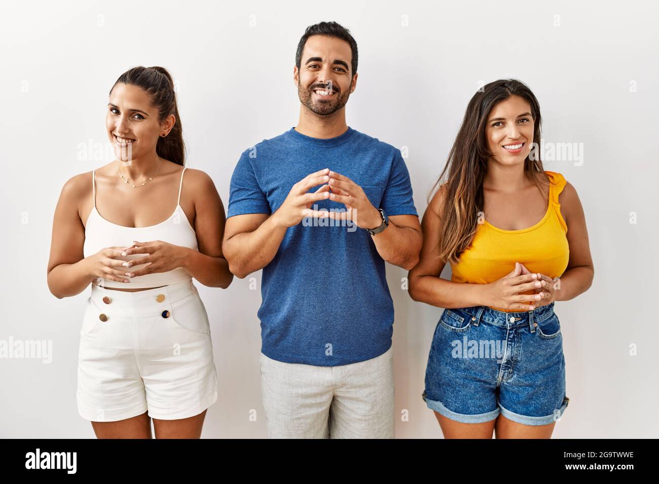 Group of young hispanic people standing over isolated background hands ...