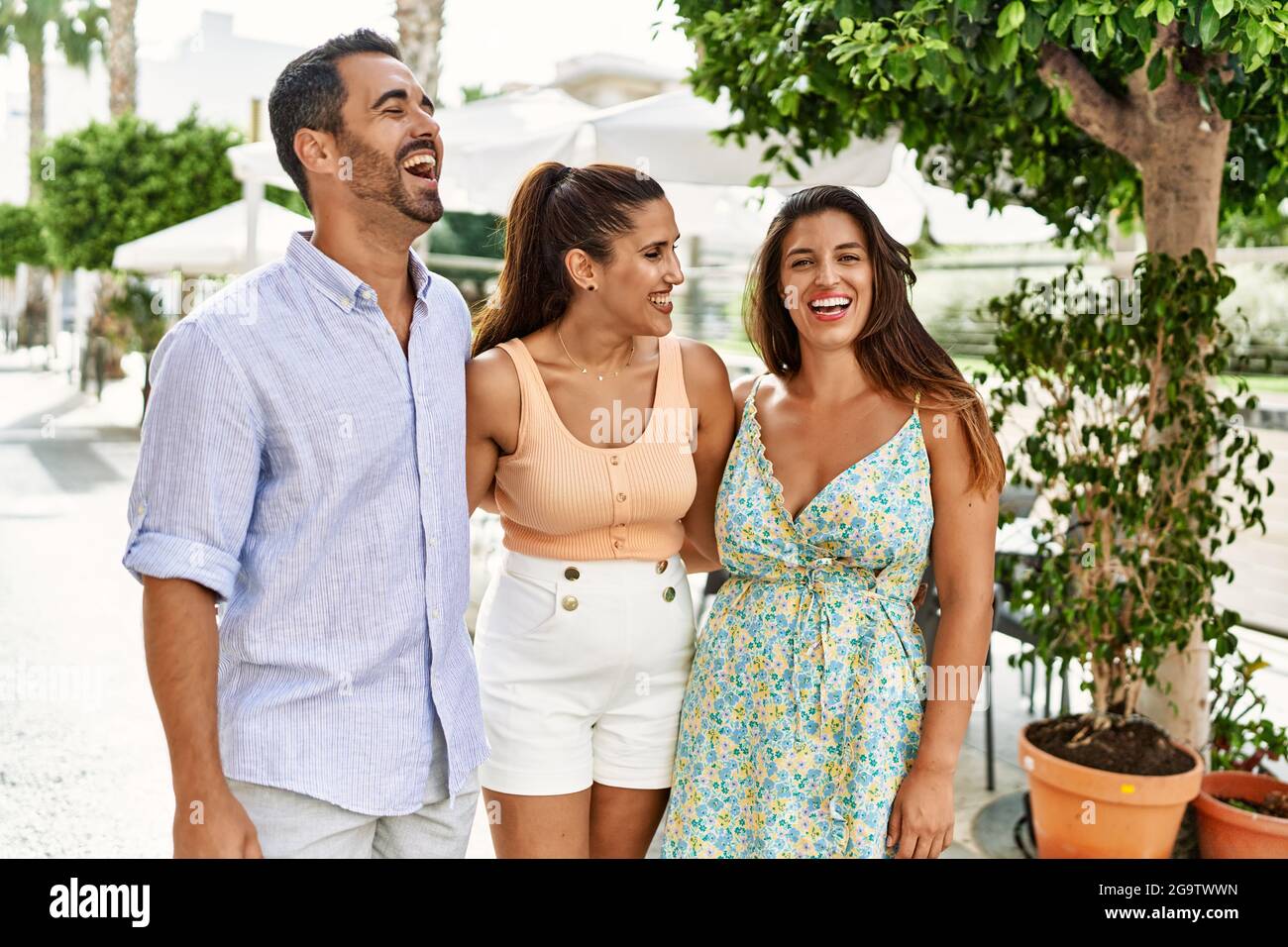 Three hispanic friends smiling happy and hugging at the city Stock ...