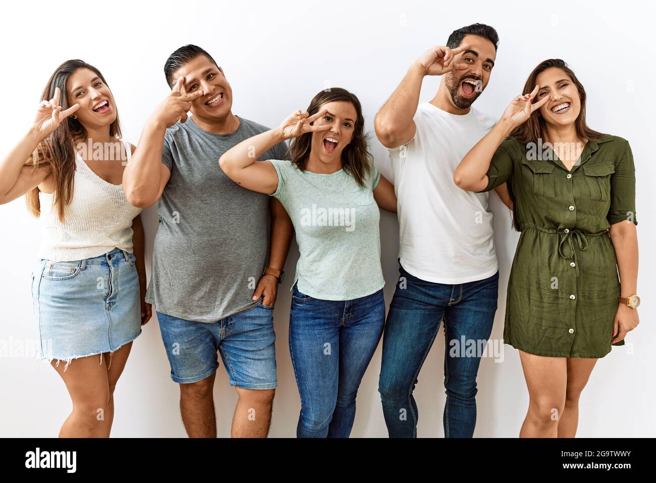 Group of young hispanic friends standing together over isolated ...