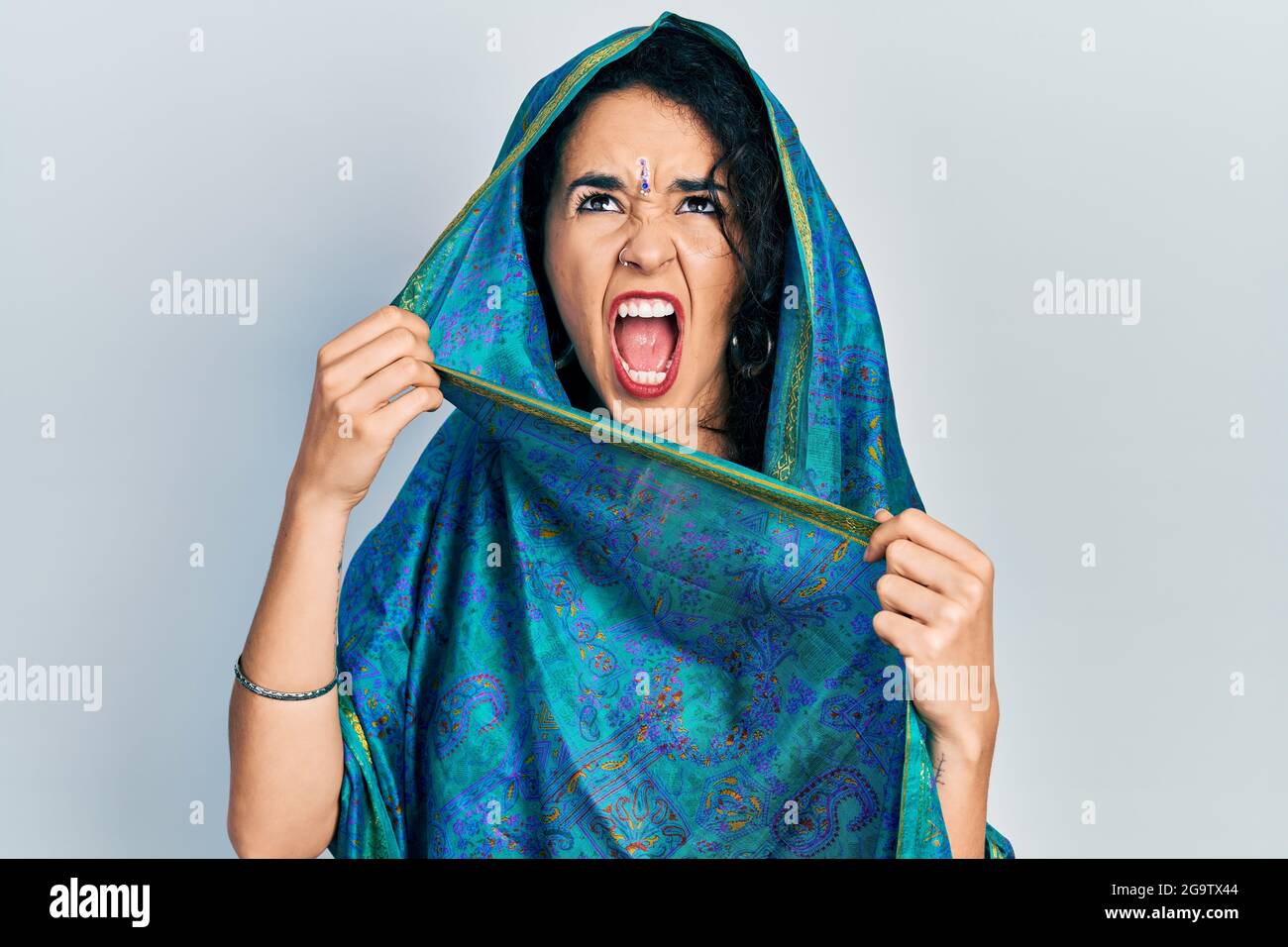 Young woman wearing bindi wearing traditional indian saree thinking ...