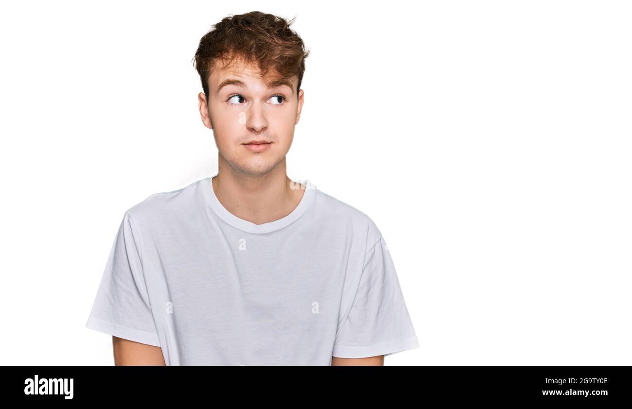 Young caucasian man wearing casual white t shirt smiling looking to the ...