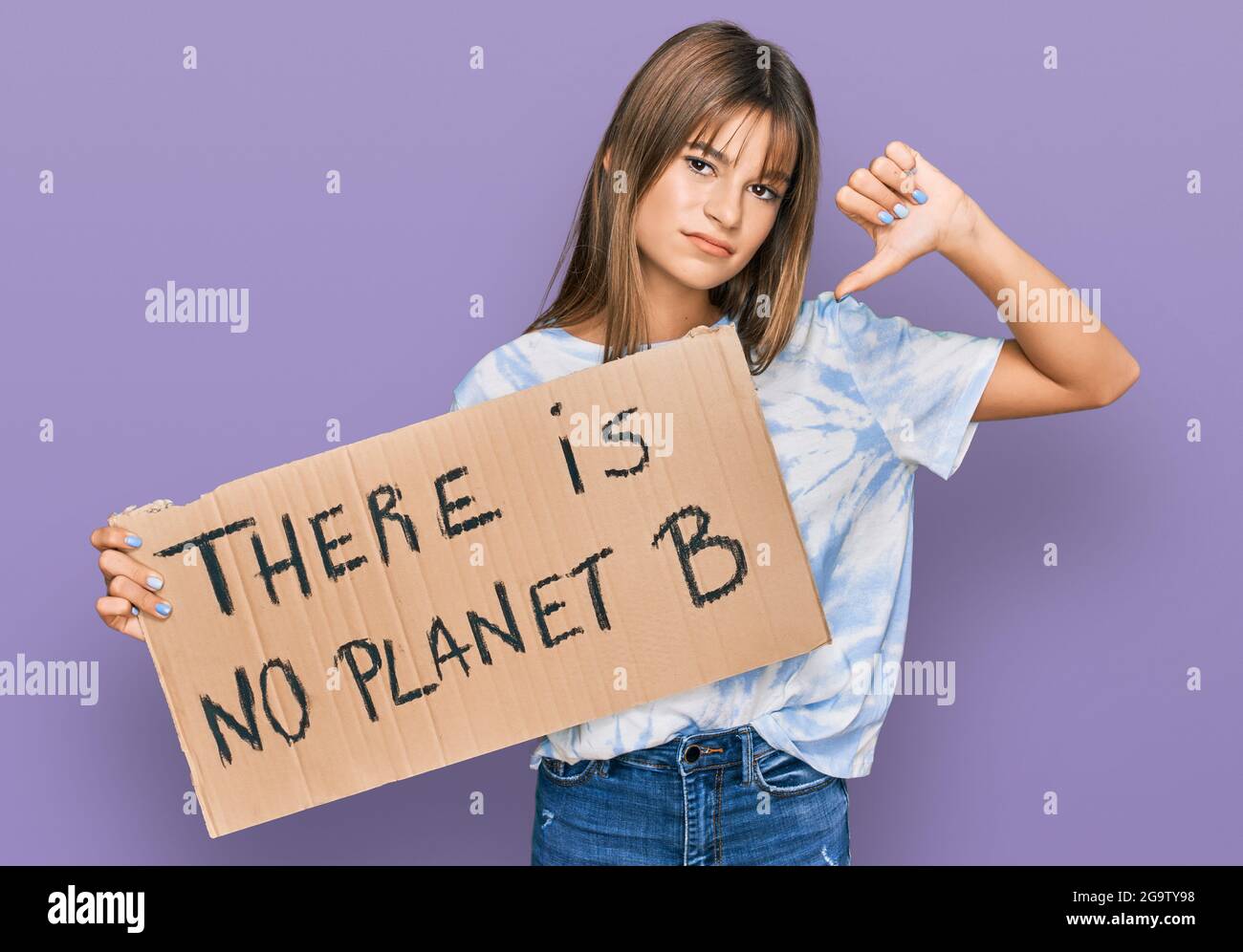 Teenager caucasian girl holding there is no planet b banner with angry ...