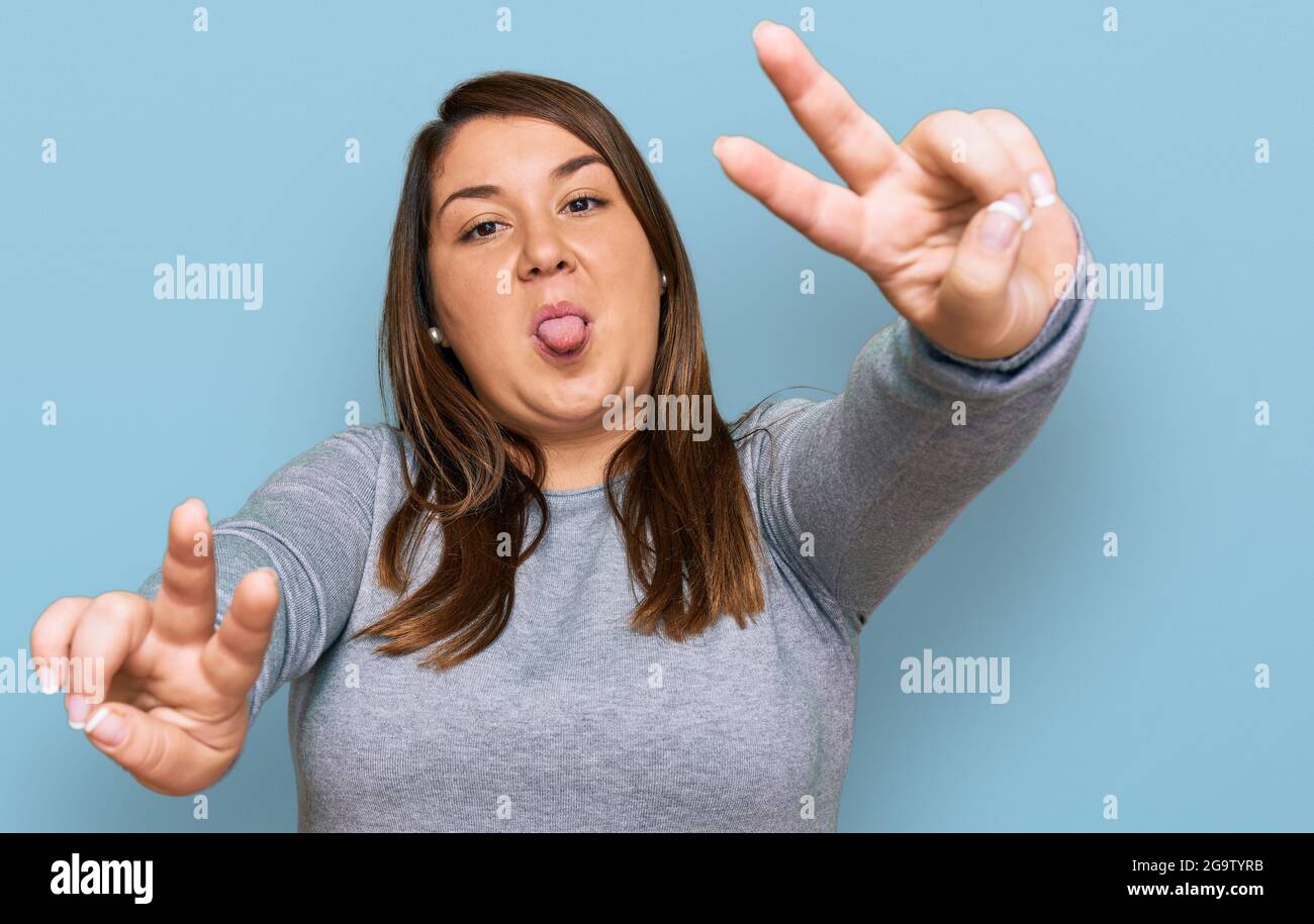 Beautiful brunette plus size woman wearing casual clothes smiling with ...