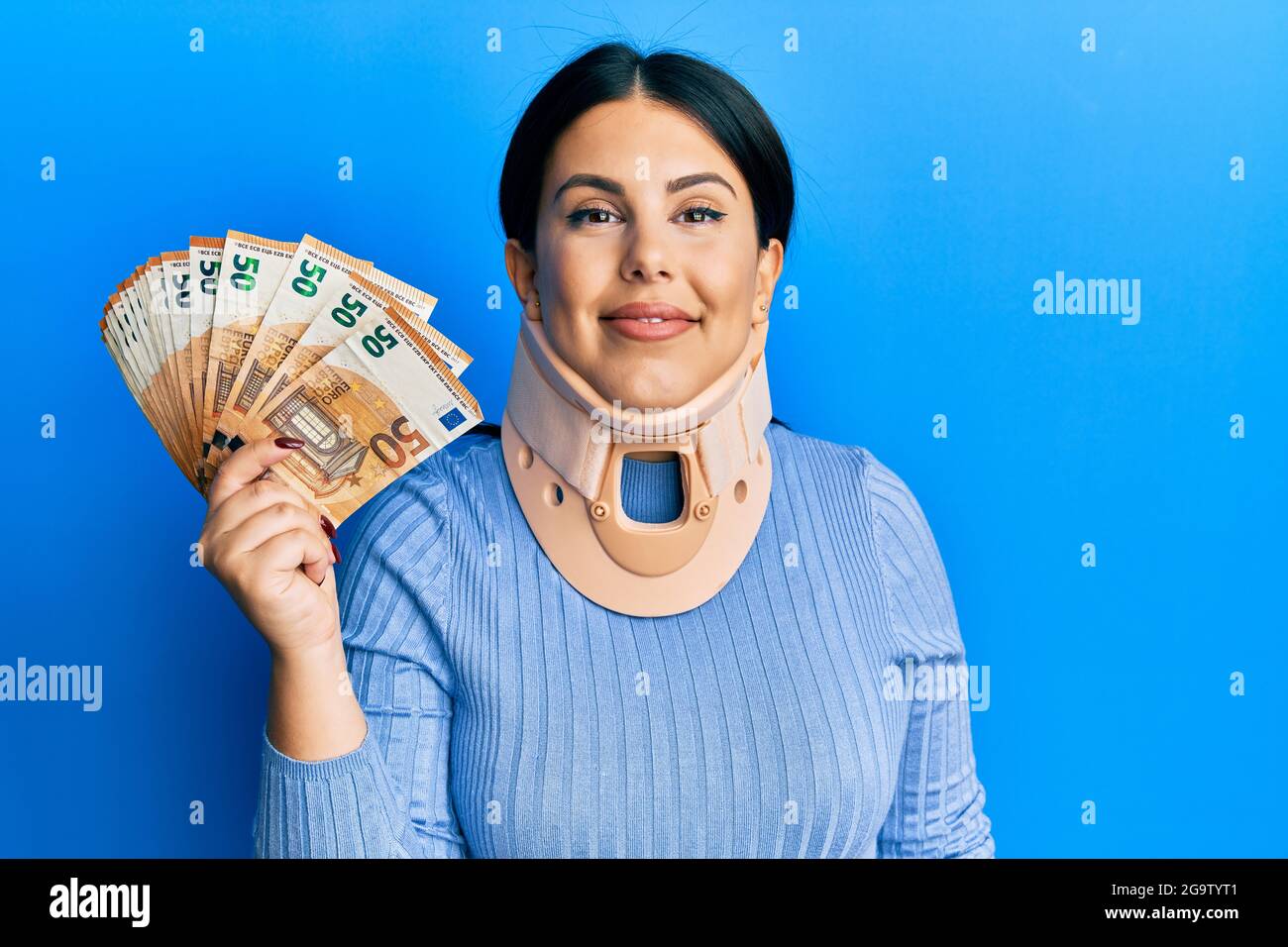 Beautiful brunette woman wearing cervical collar holding insurance ...